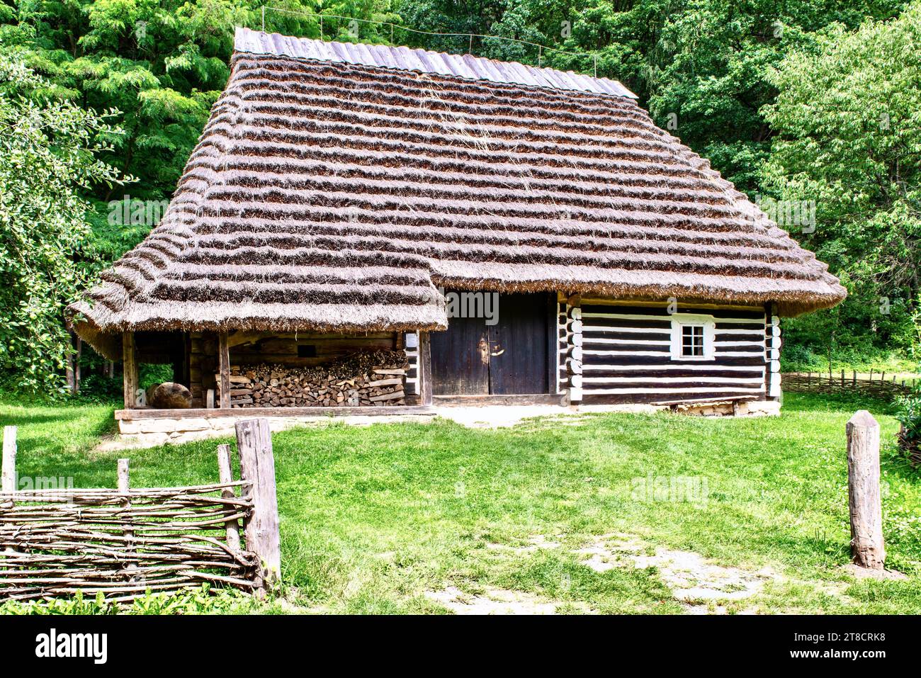 A fragment of a traditional Polish house with a thatched roof and a ...