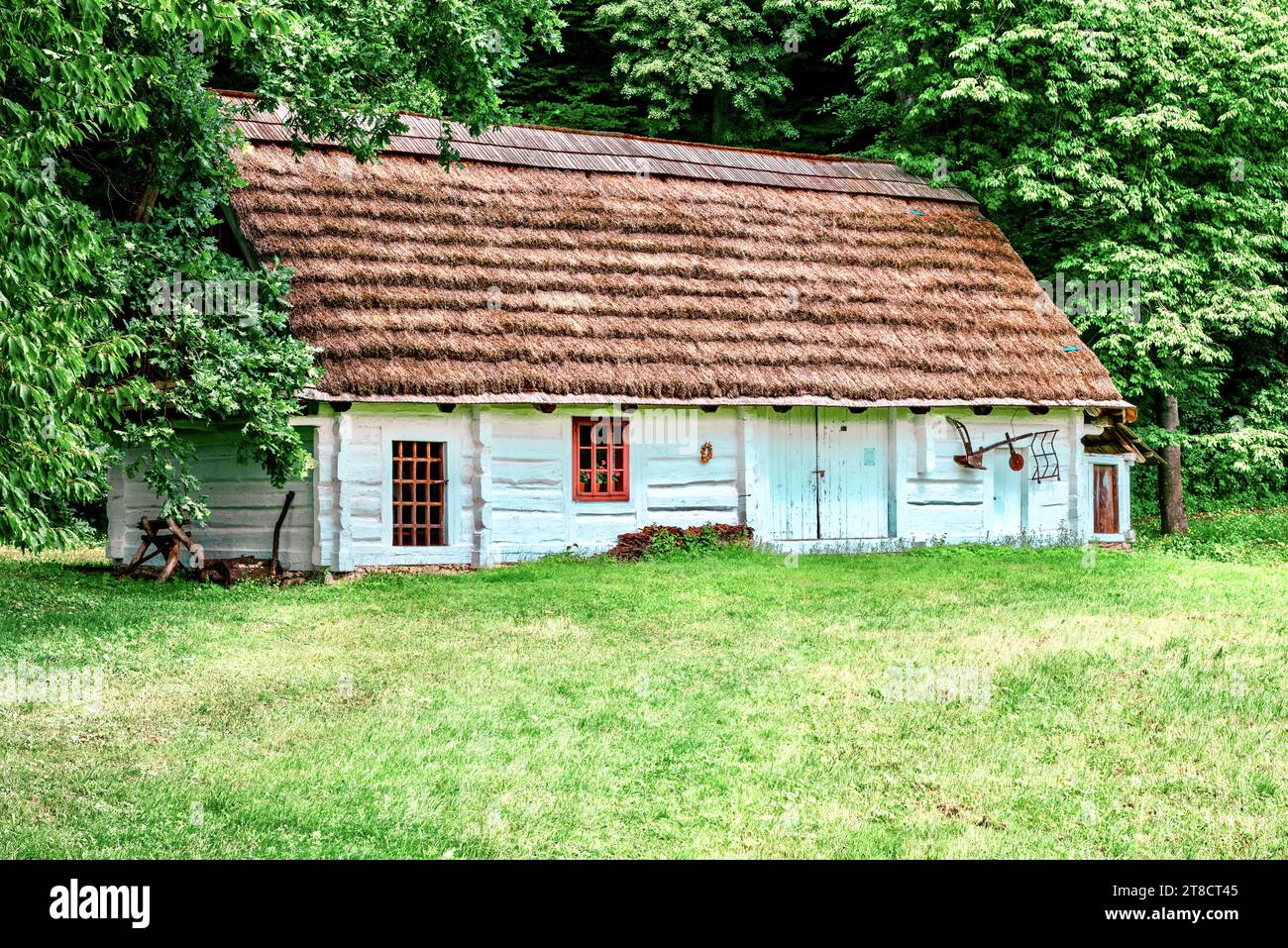 A fragment of a traditional Polish house with a thatched roof and a ...