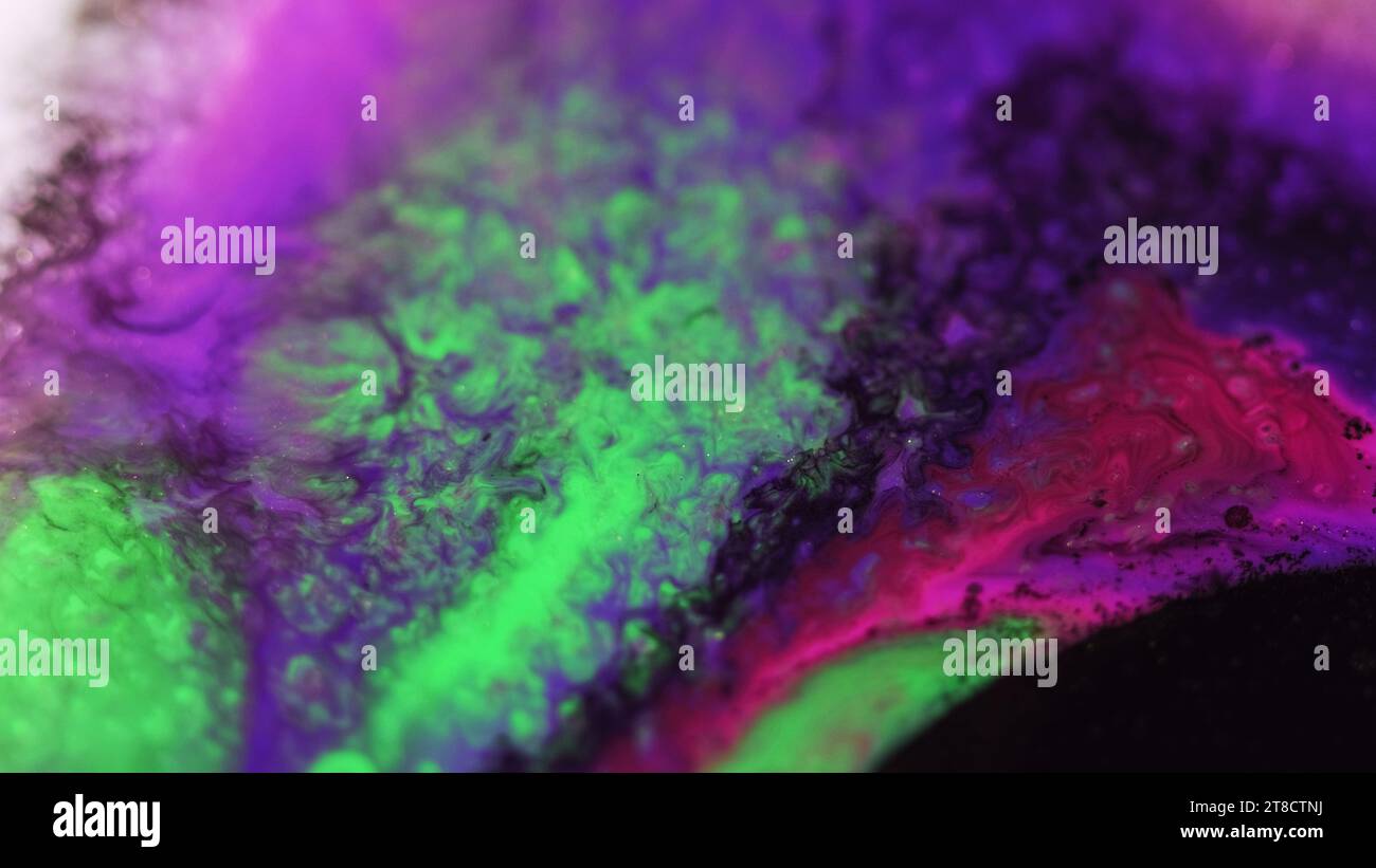 Paint spill neon mist color ink water drip wave Stock Photo - Alamy