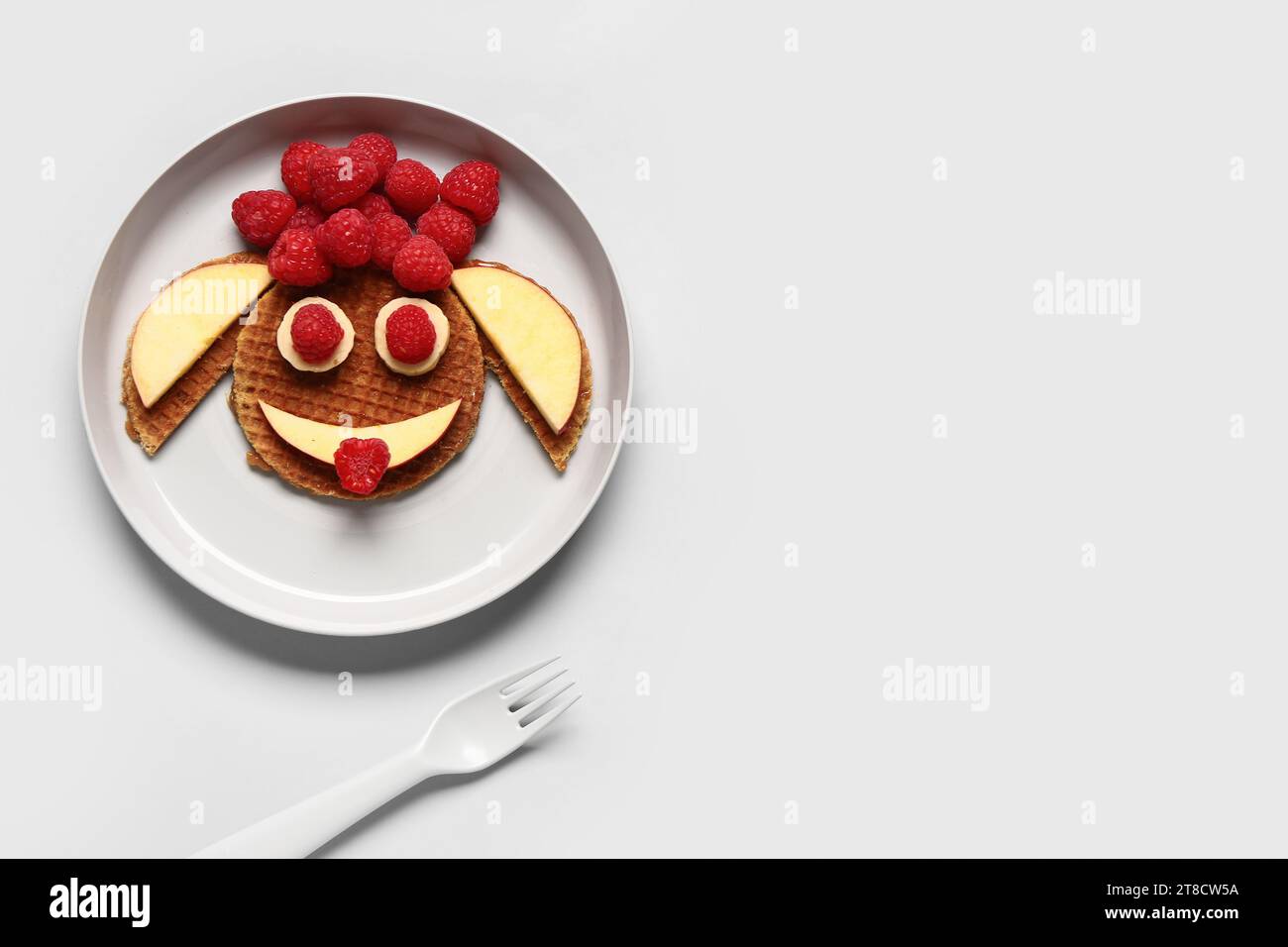 Plate with creative children's breakfast in shape of funny face on ...