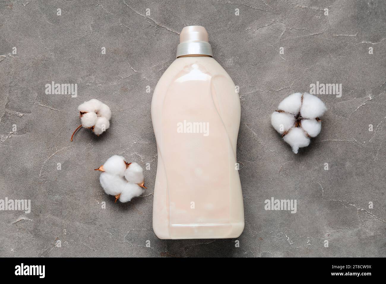 Bottle of laundry detergent with cotton flowers on grey grunge ...