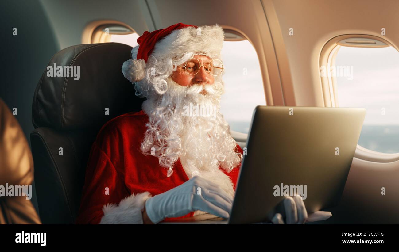 Santa Claus working on the laptop sitting on board the plane Stock ...