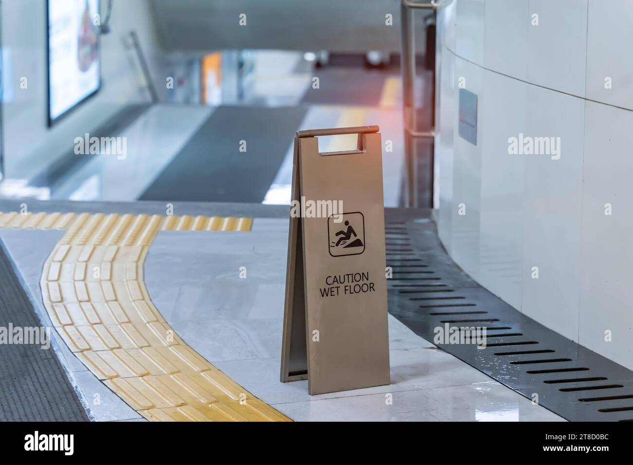 metal caution wet floor sign on wet floor Stock Photo - Alamy
