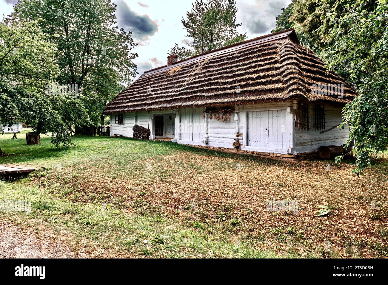A fragment of a traditional Polish house with a thatched roof and a ...