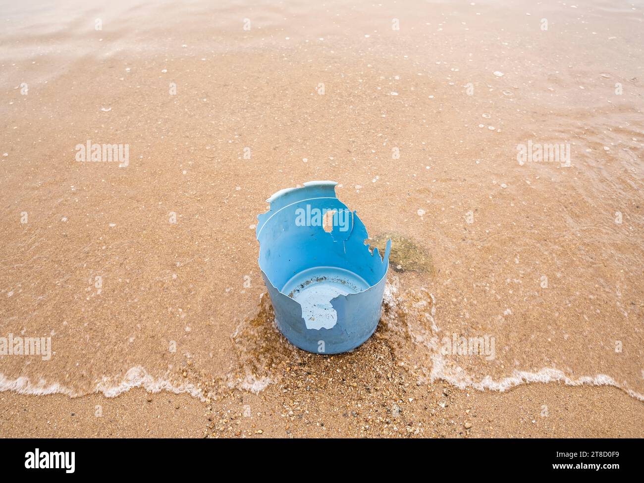 Broken blue plastic bucket on a sandy beach Stock Photo - Alamy
