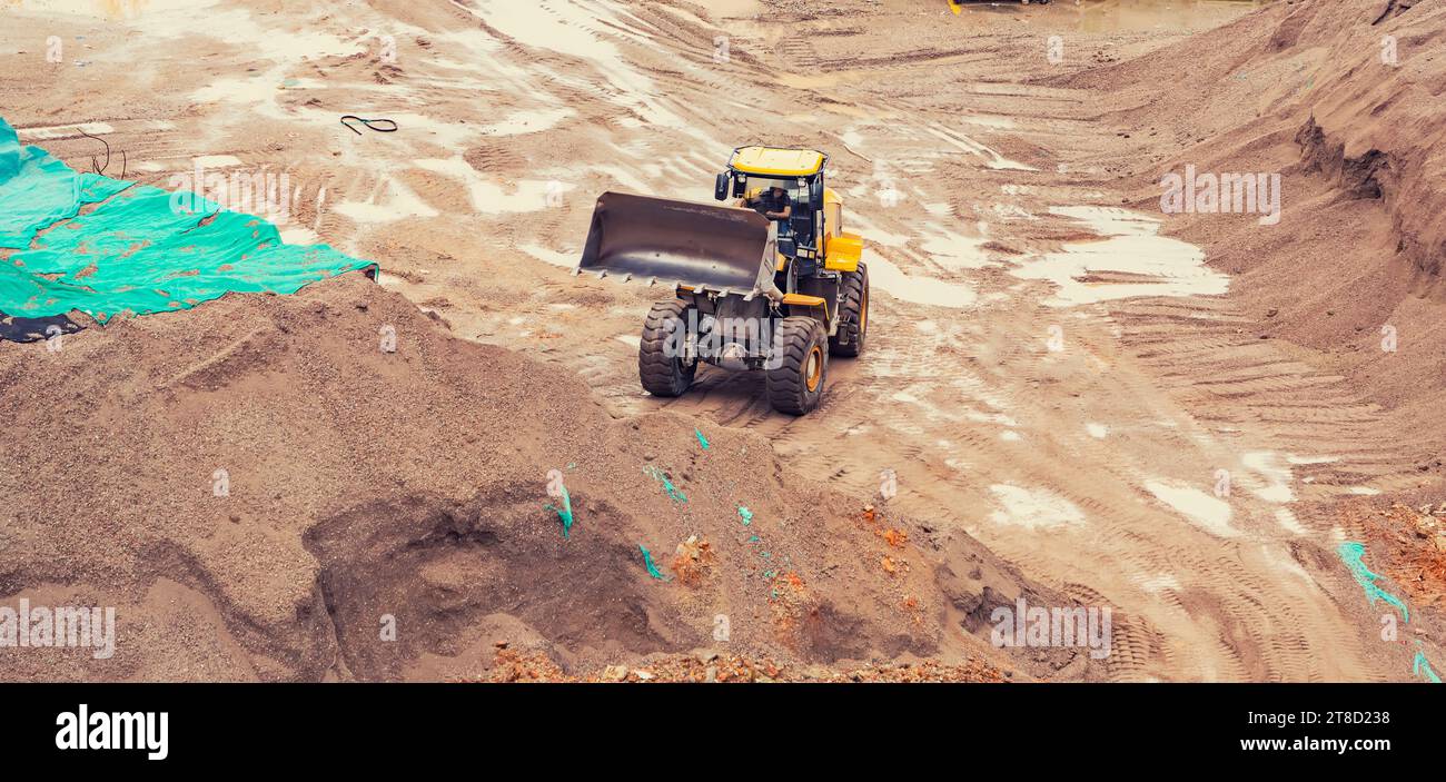 excavator loader machine during earthmoving works outdoors Stock Photo ...