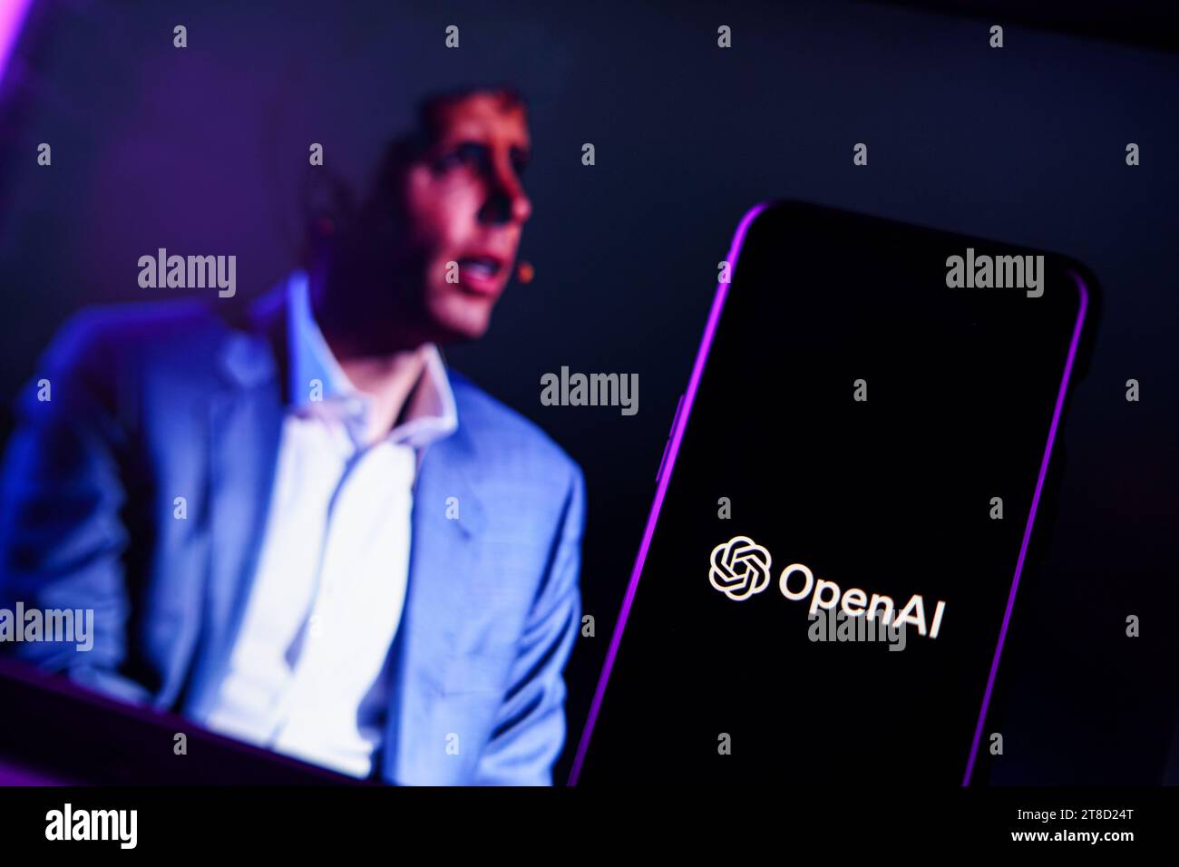 OpenAI logo and Sam Altman in background on screen. OpenAI fires CEO ... OpenAI logo and Sam Altman in background on screen. OpenAI fires CEO ...