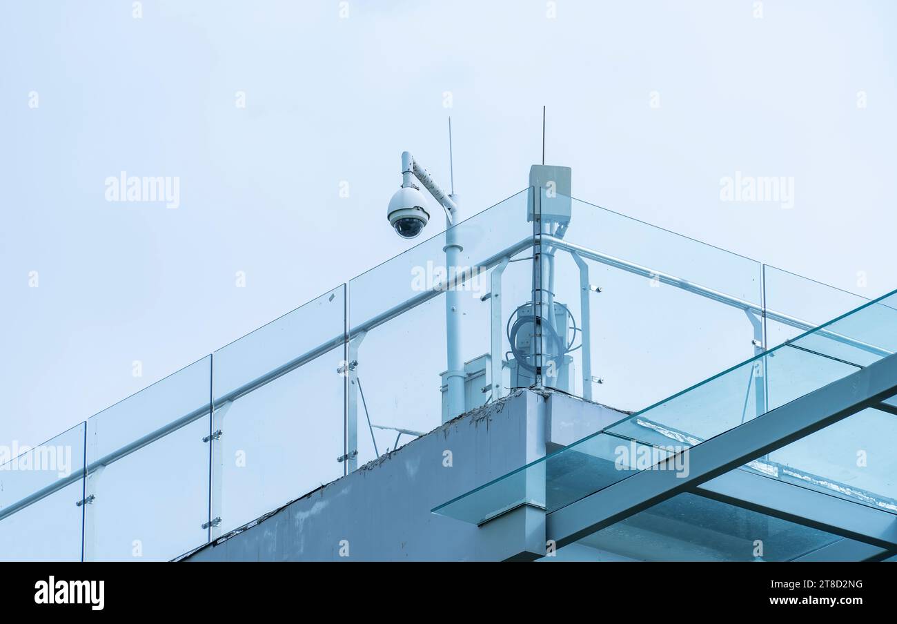 security camera on the glass fence Stock Photo - Alamy