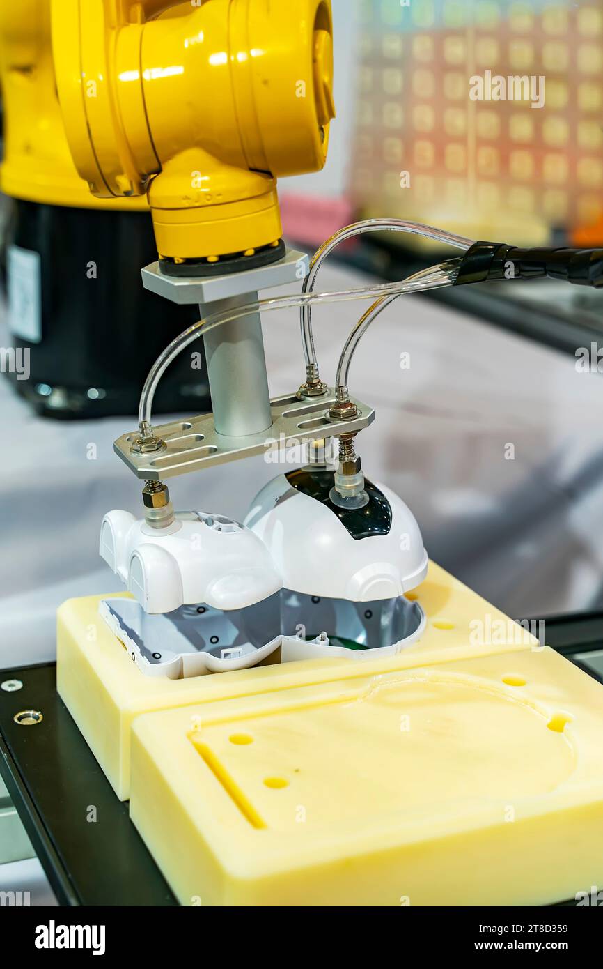 automatic arm sucker catch for electronic robot toy assembly line. The ...