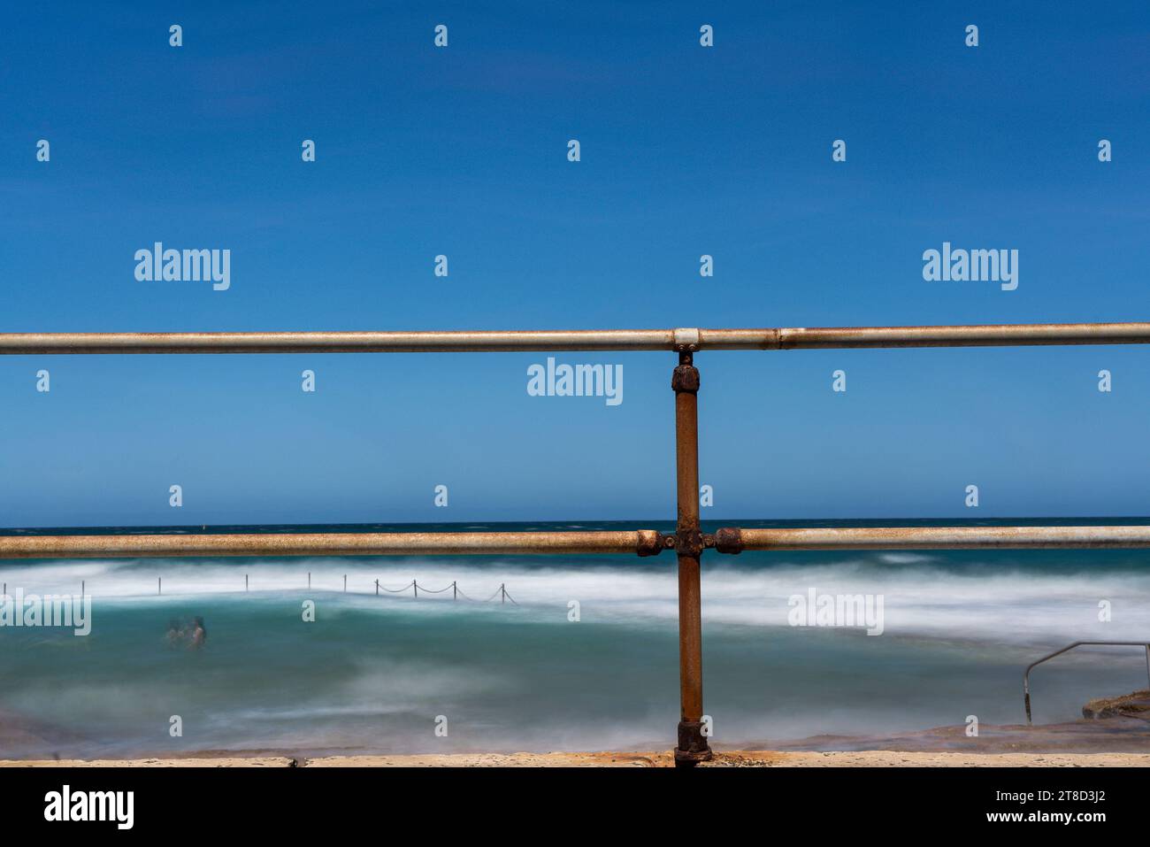 An abstract view of Cronulla Beach Sydney through the pathway railing ...