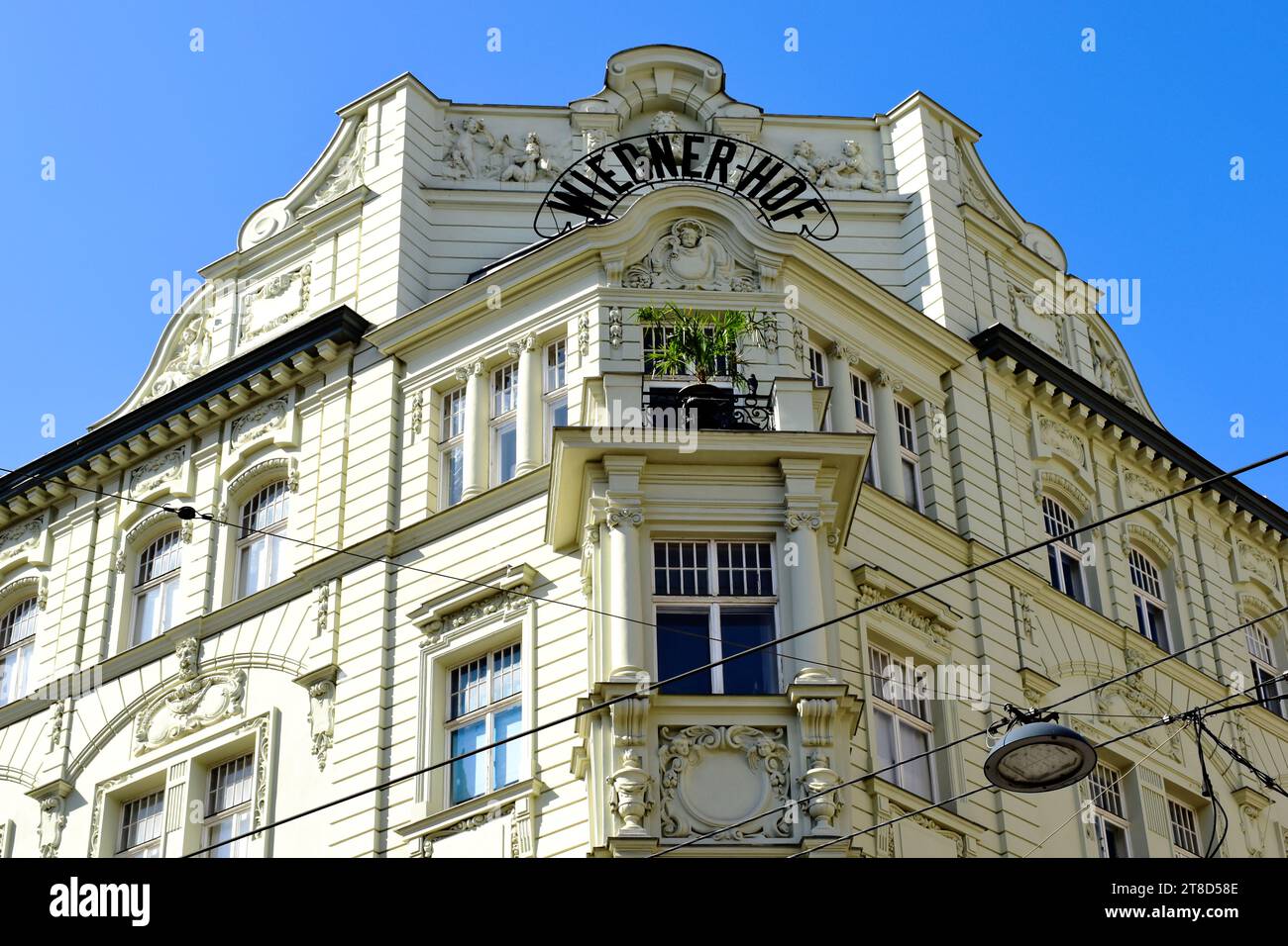 classic old condominium building stucco facade and balcony. green palm ...