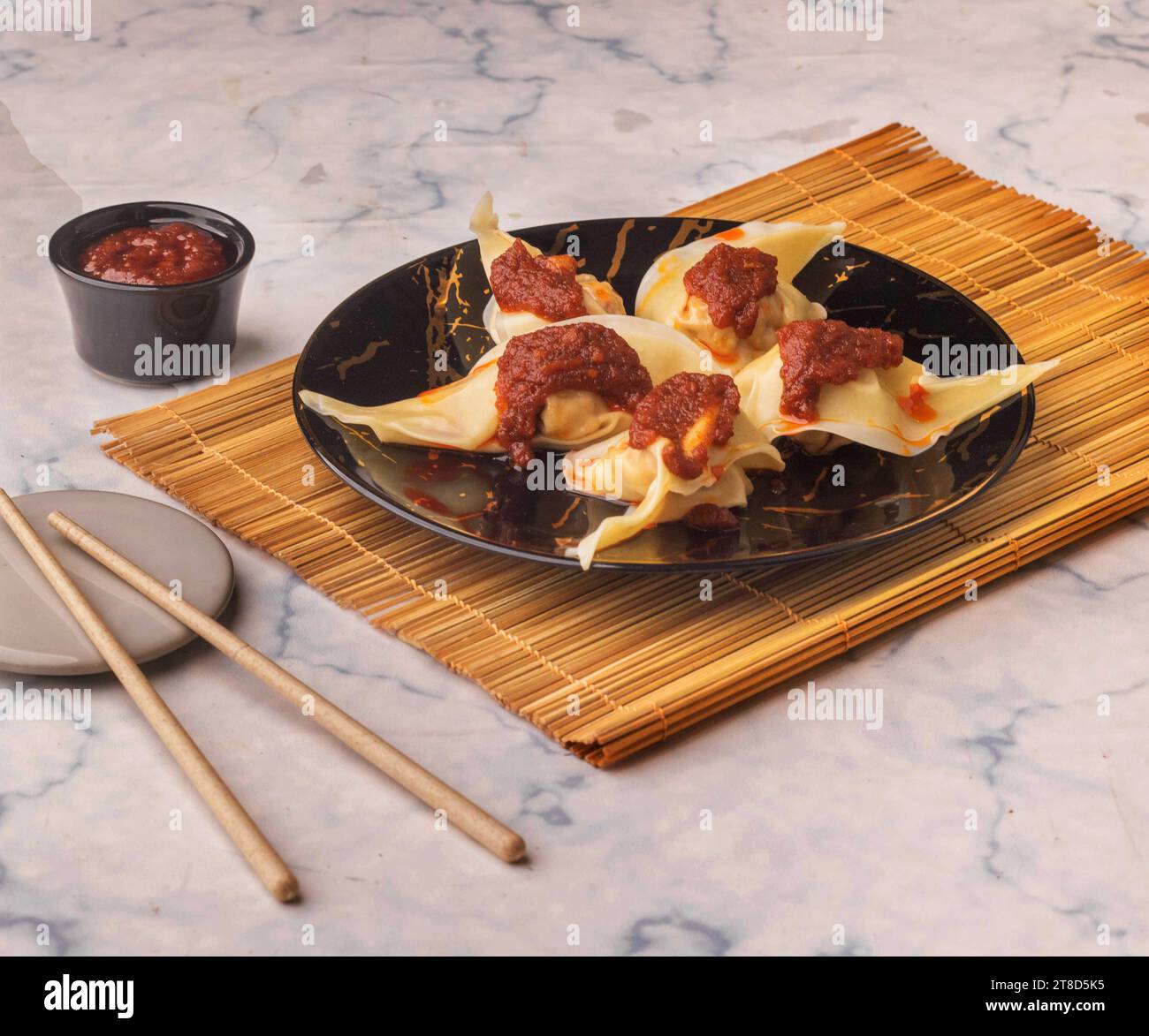 Steamed wonton in red chili oil,Steamed wonton on plate in white ...