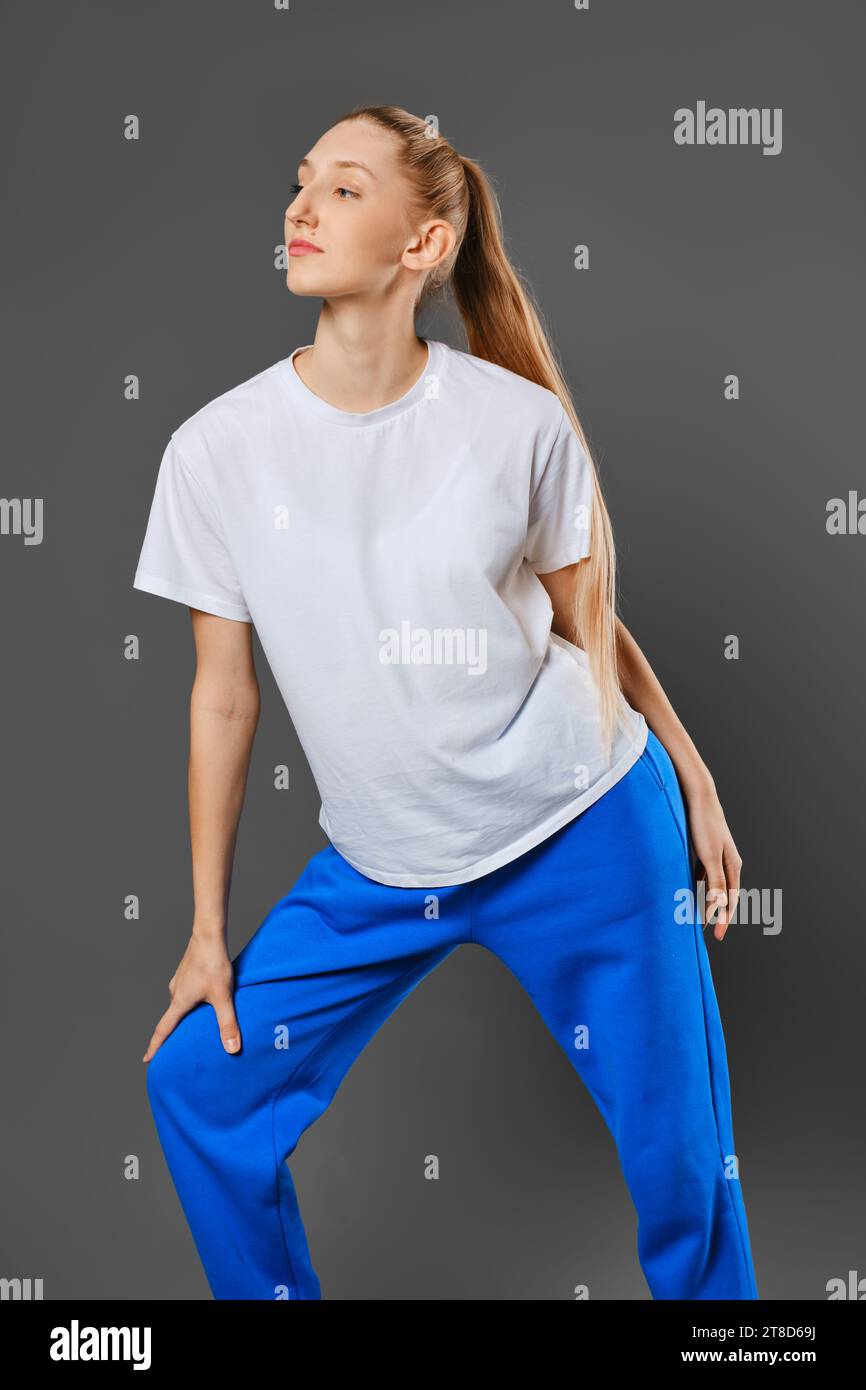 Young sportive woman bend forward over grey studio background Stock ...