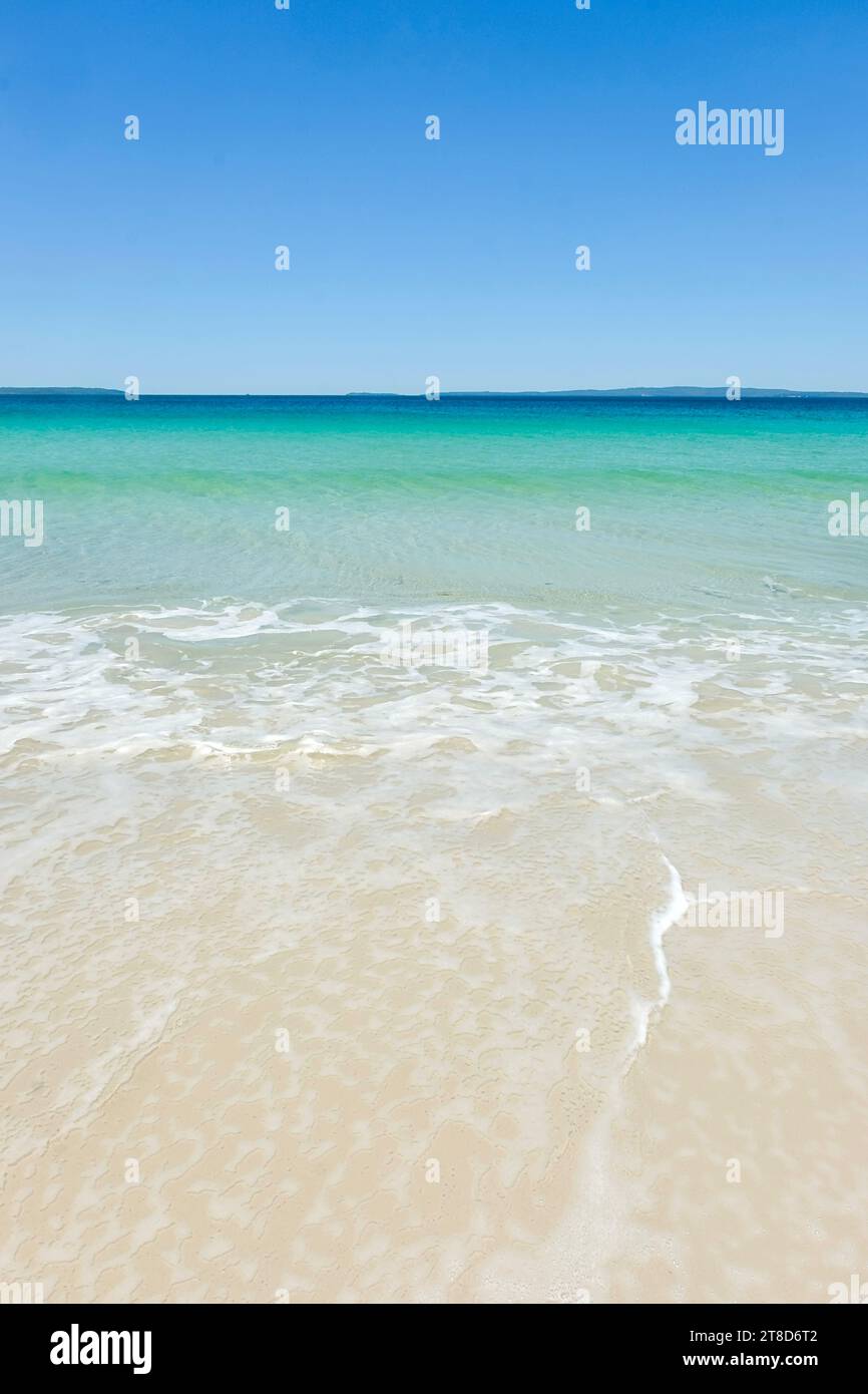 Clear turquoise waters, cloudless blue skies, sea foam and white sand ...
