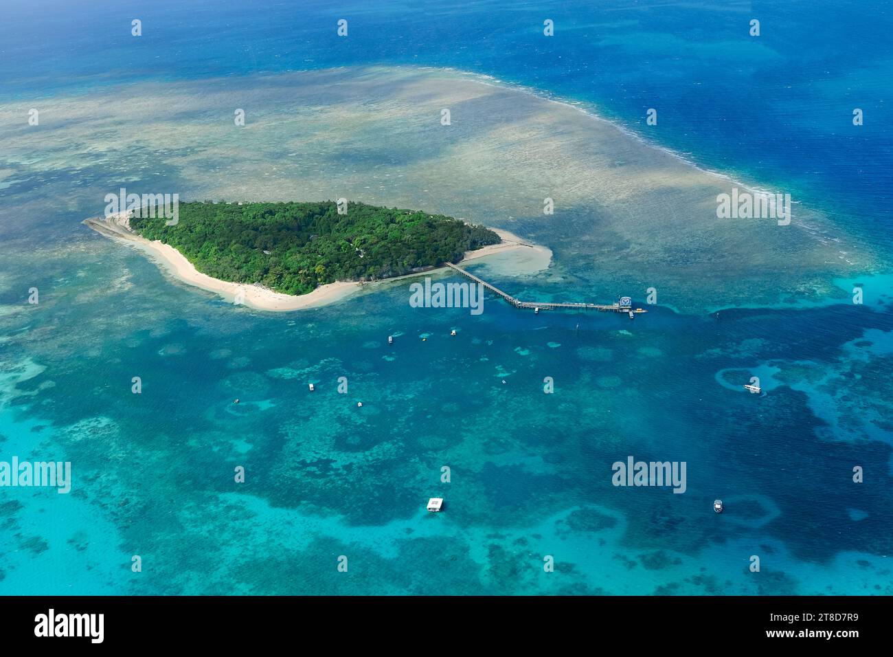 An aerial view of the coral reefs and clear turquoise waters ...