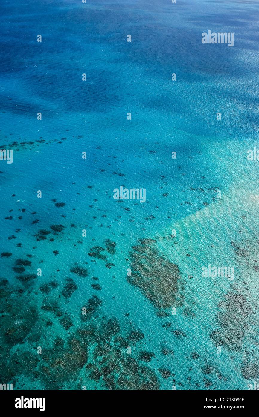 An aerial view of the coral reefs, white sand bars, tropical isles and ...