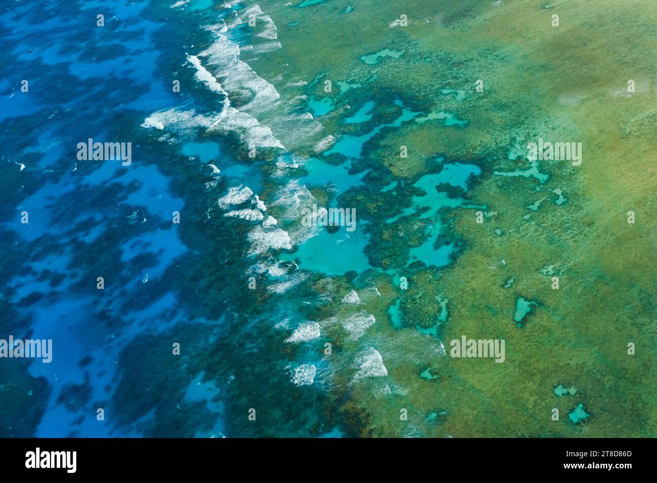 An aerial view of the coral reefs, white sand bars, tropical isles and ...