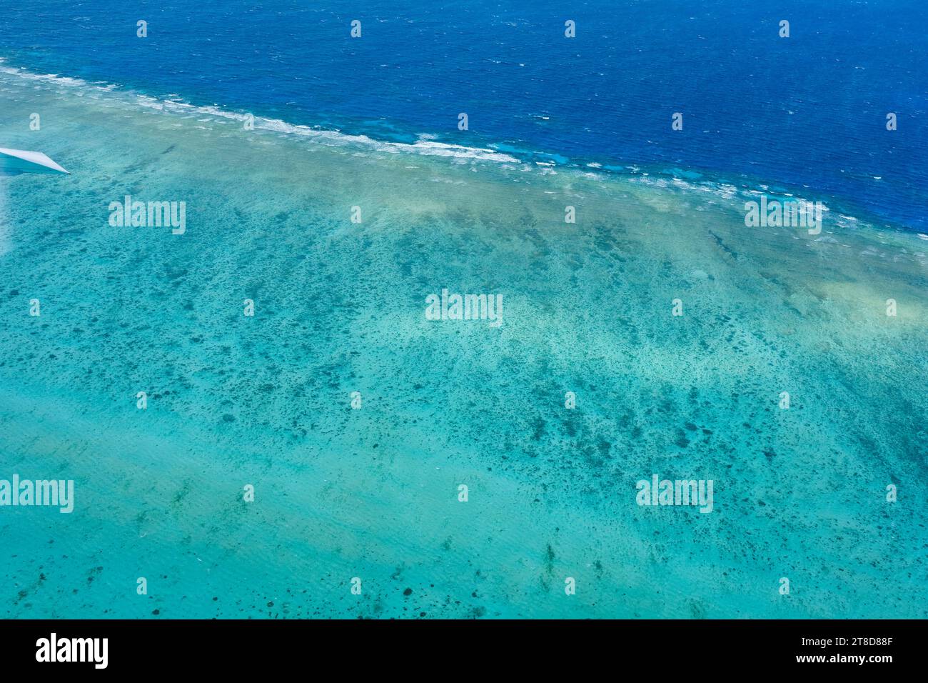 An aerial view of the coral reefs, white sand bars, tropical isles and ...