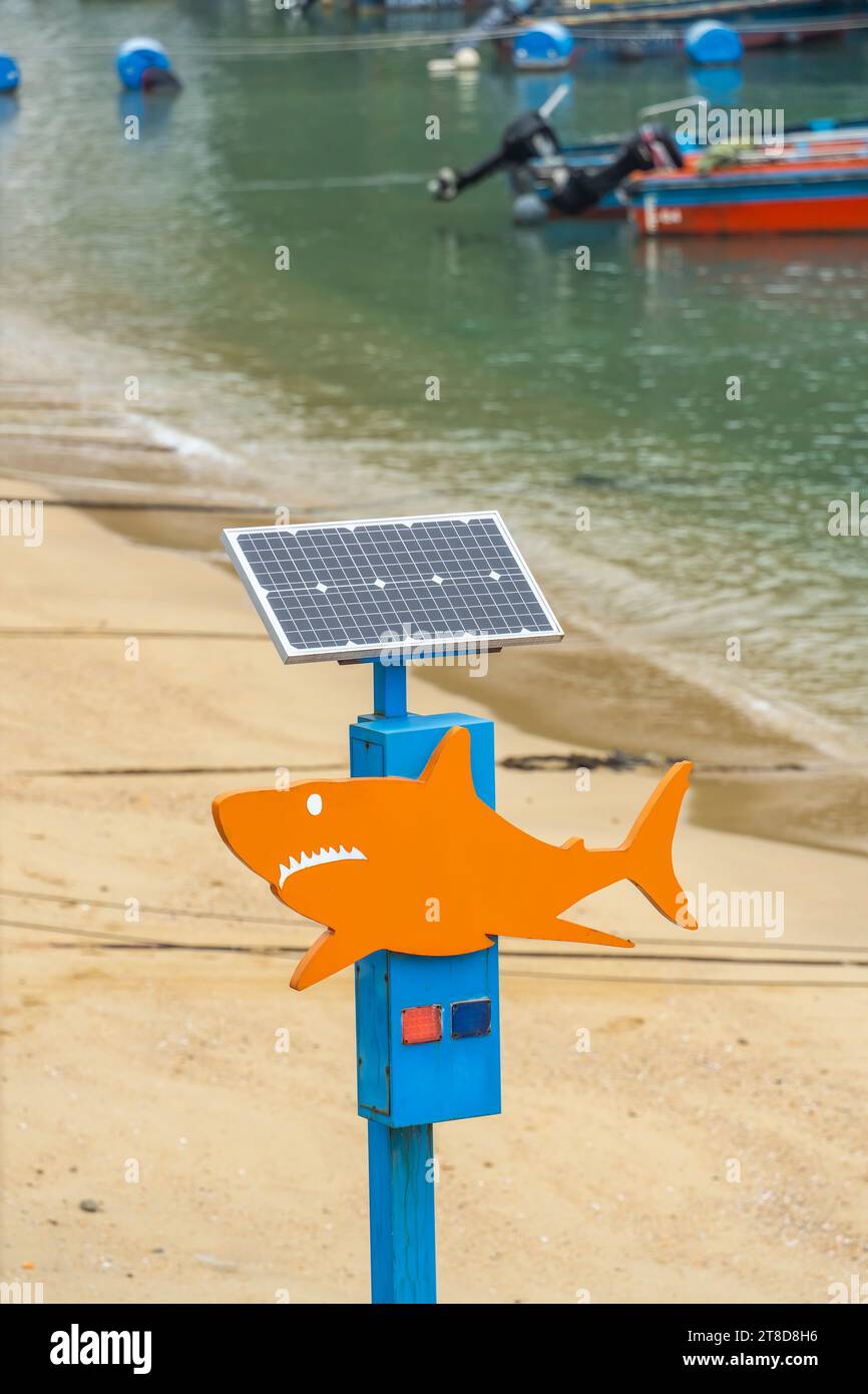 Solar-powered megaphones pole with warning sign caution sharks Stock ...