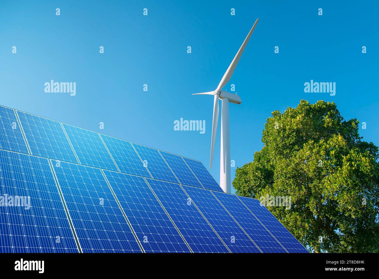 wind turbine with solar panels in blue sky. concept of clean energy ...