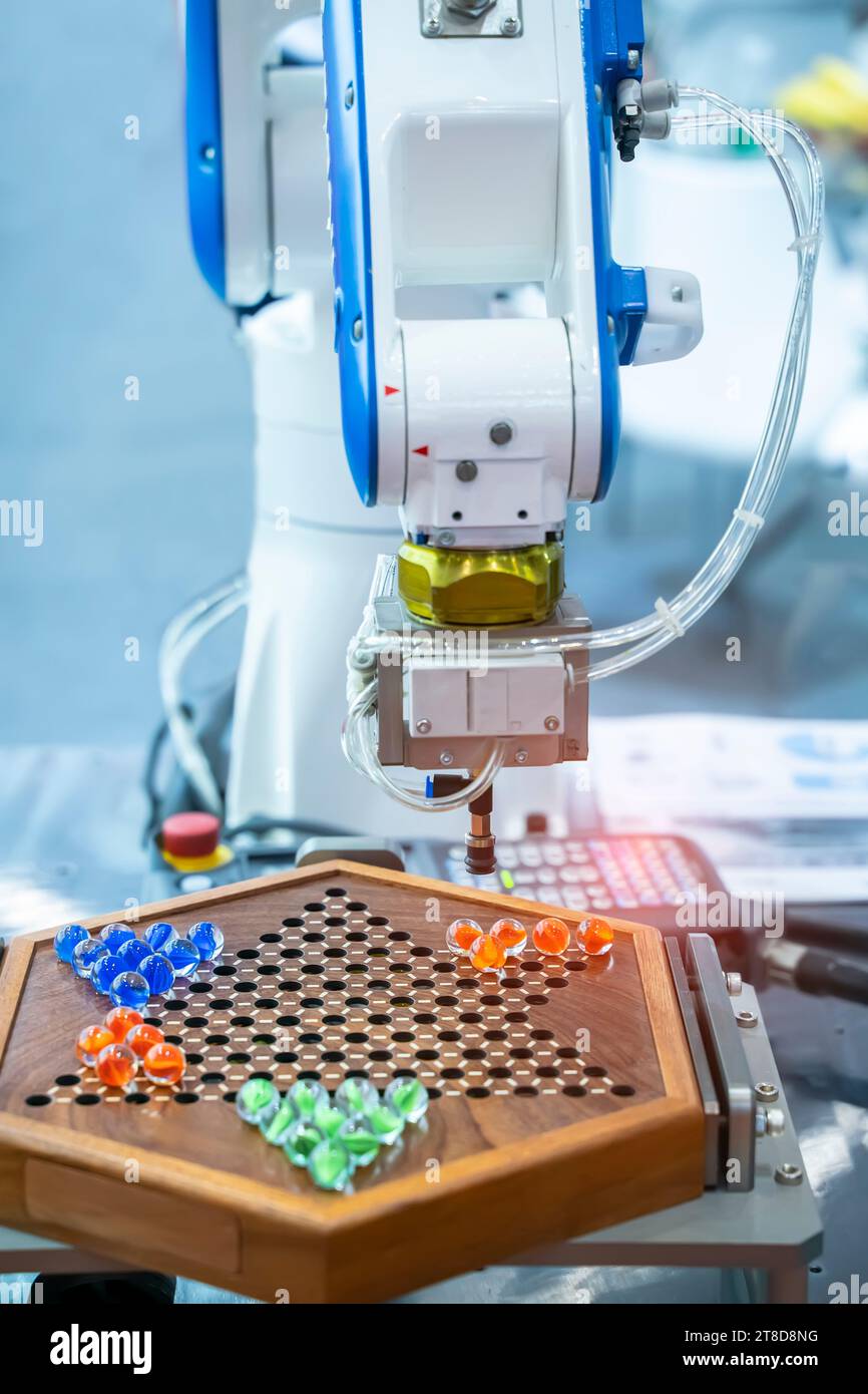 automatic robot hand playing checkers Stock Photo - Alamy