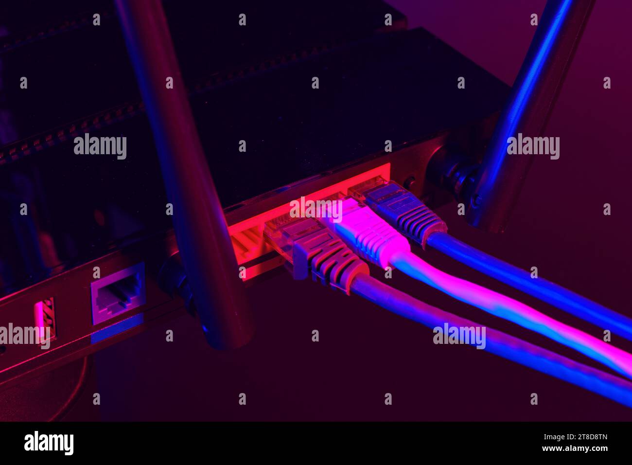 Cables plugged in a Wi-Fi router on dark background Stock Photo - Alamy