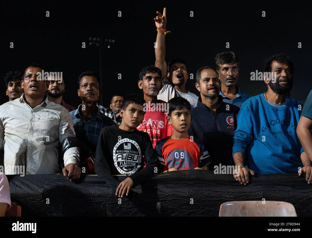 Guwahati, Assam, India. 19th Nov, 2023. Cricket fans in a field watch ...