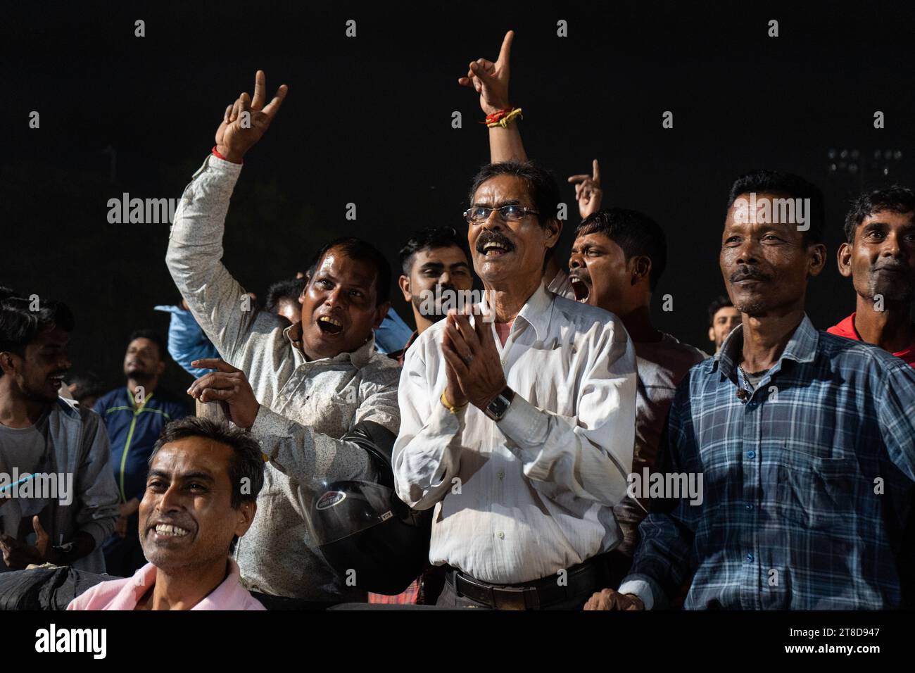 Guwahati, Assam, India. 19th Nov, 2023. Cricket fans in a field watch ...