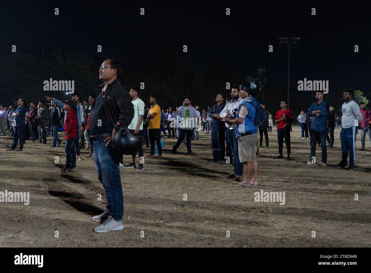 Guwahati, Assam, India. 19th Nov, 2023. Cricket fans in a field watch ...