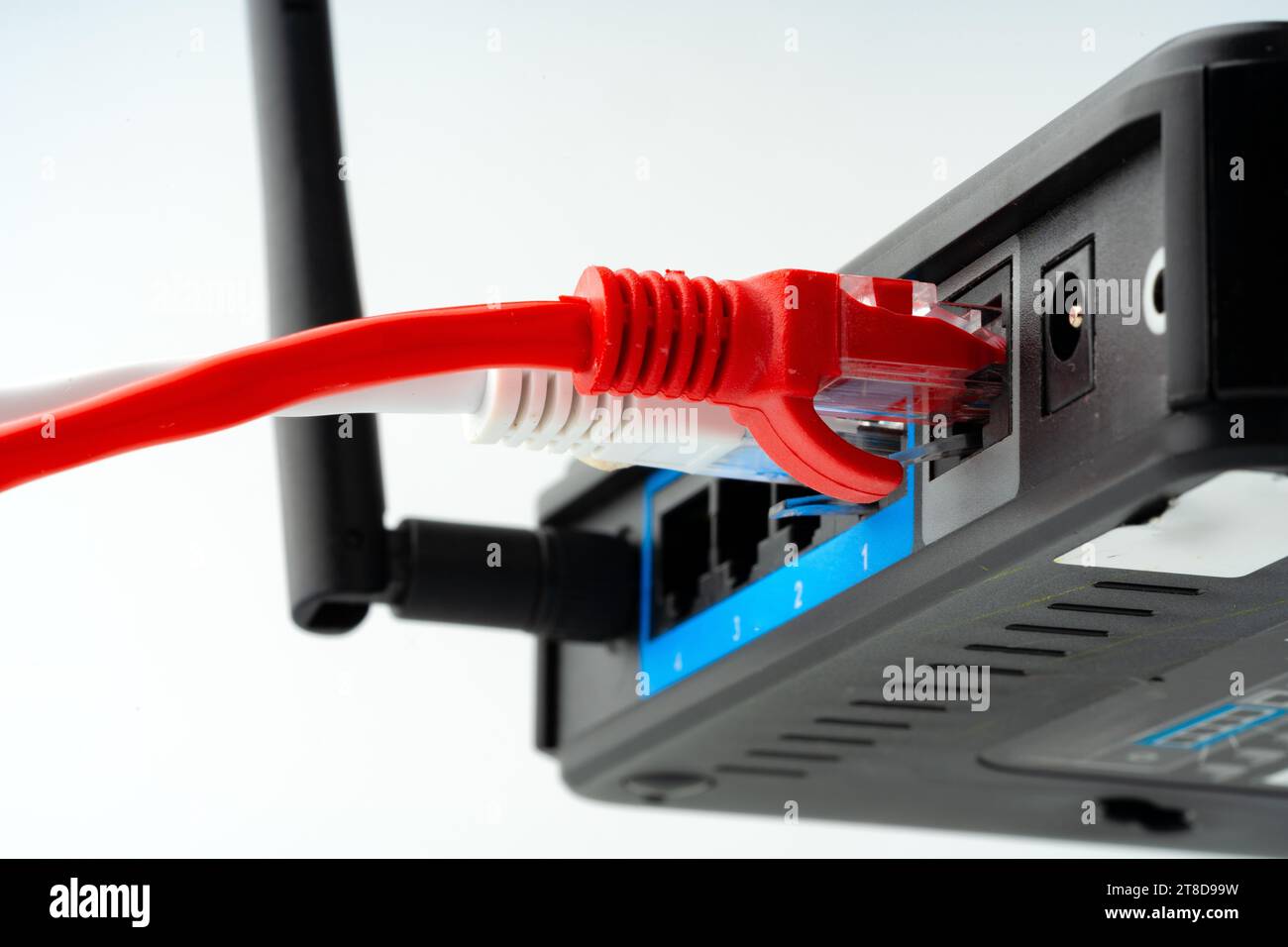 Modern router with cables plugged in close up Stock Photo - Alamy
