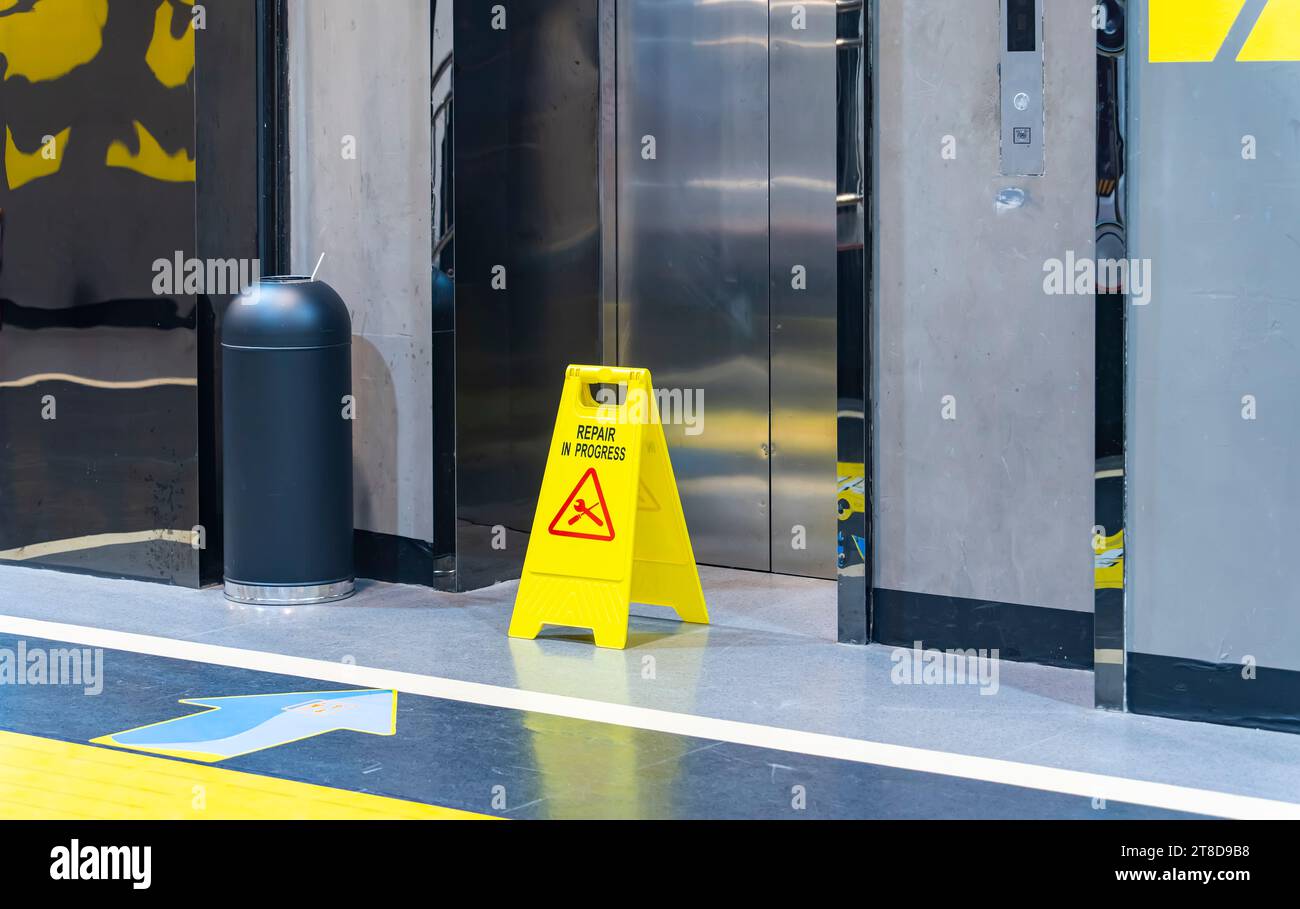 repair in progress sign near an lift, warning sign Stock Photo - Alamy