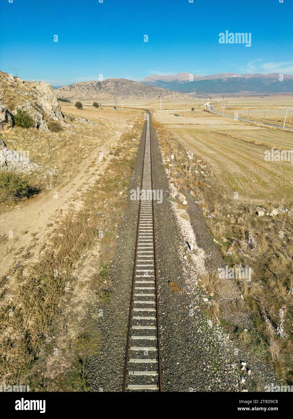 Top view of the train track passing through the arid land, taken with a ...