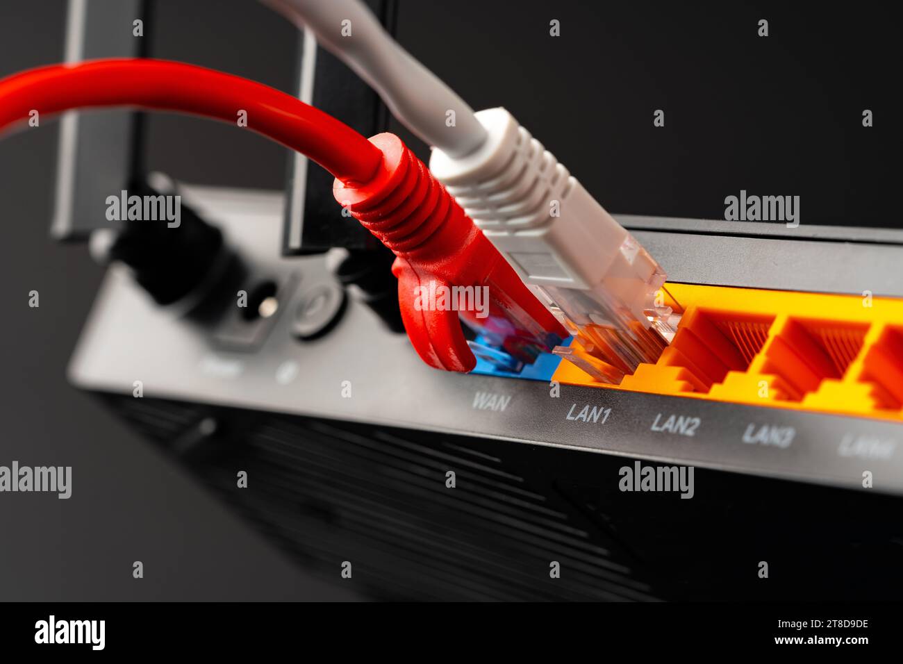Modern router with cables plugged in close up Stock Photo - Alamy