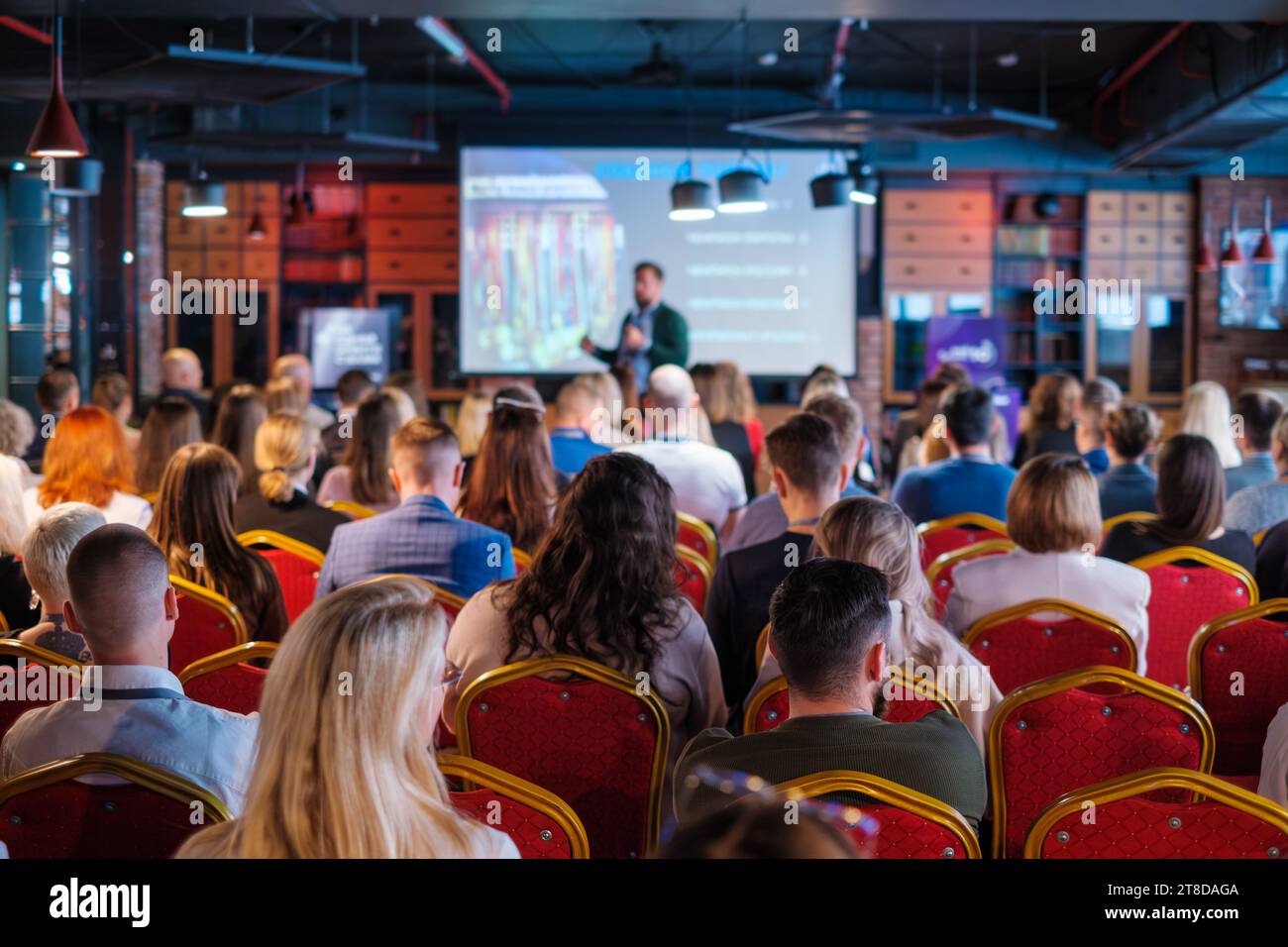 Back view of diverse businesspeople attending global workshop in ...