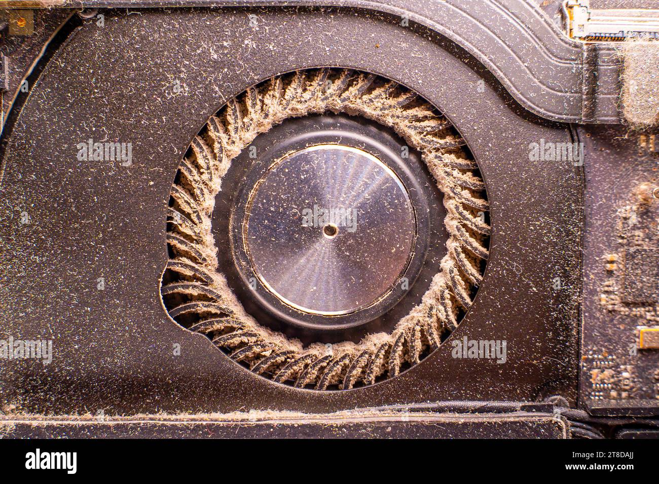 Close-up of a jammed cooling cooler and overheating of the laptop. Dust ...