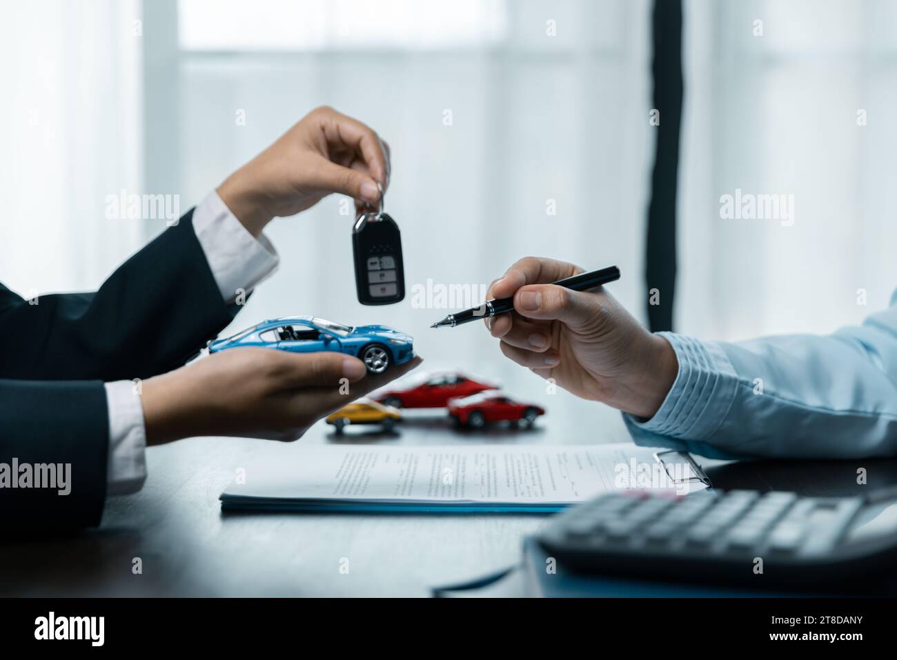 Toy Car In Front Of Businessman Calculating Loan. Saving money for car ...