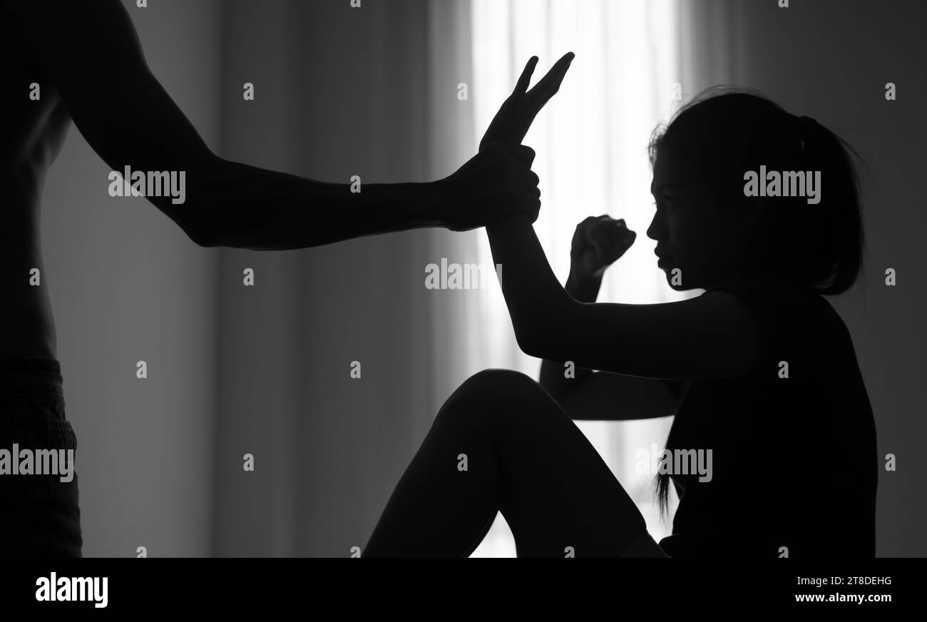 Silhouette of a man assaulting a defenseless woman. Concept of Stop ...