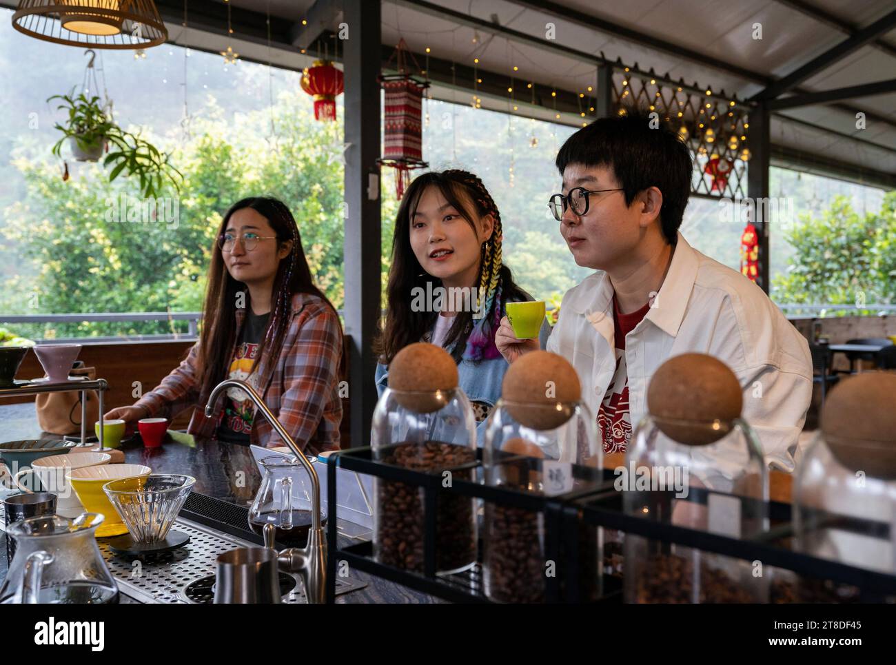 Kunming, China's Yunnan Province. 22nd Feb, 2022. Tourists taste coffee ...