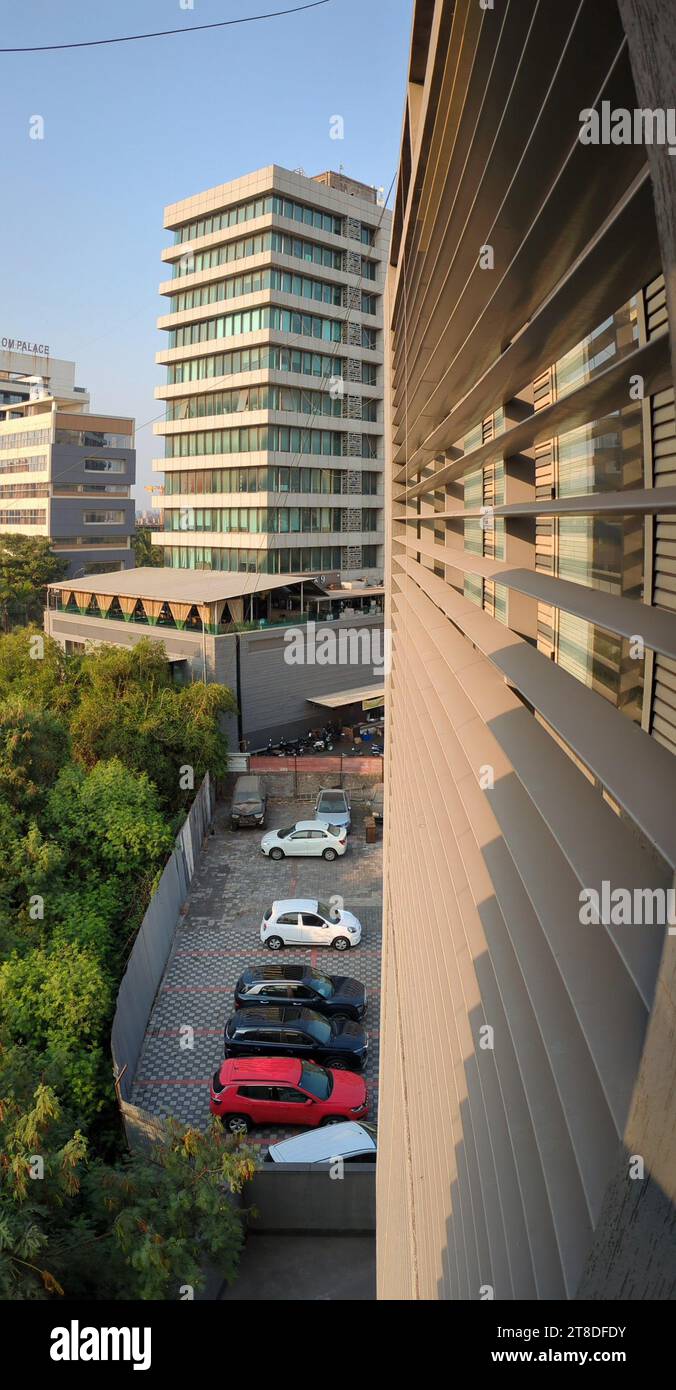 A vertical view from a window overlooking modern buildings and a ...