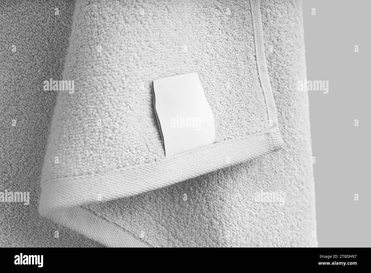Mockup of a textured white towel with a label, close-up, for design ...