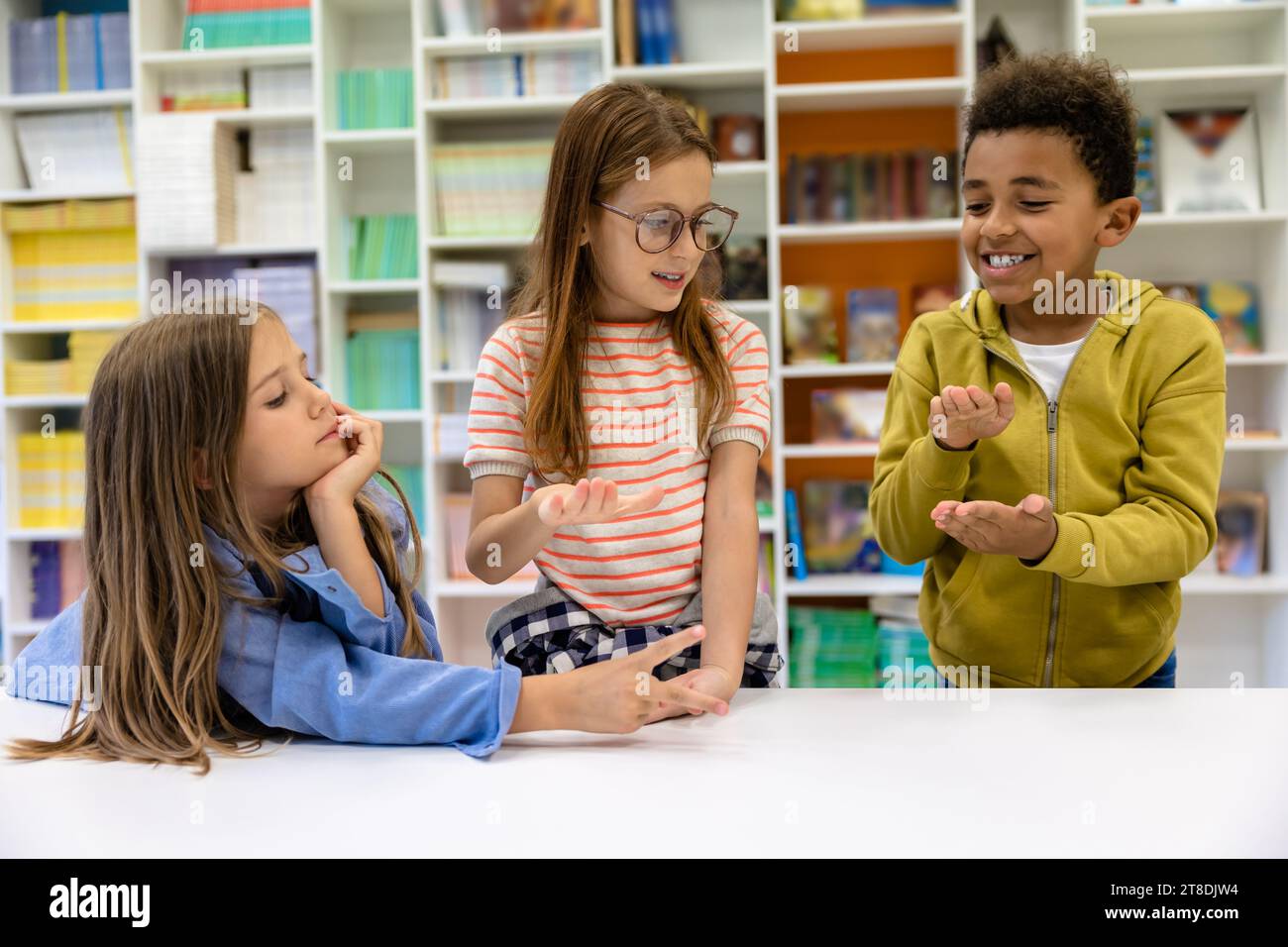 Children sitting in school library Stock Photo - Alamy