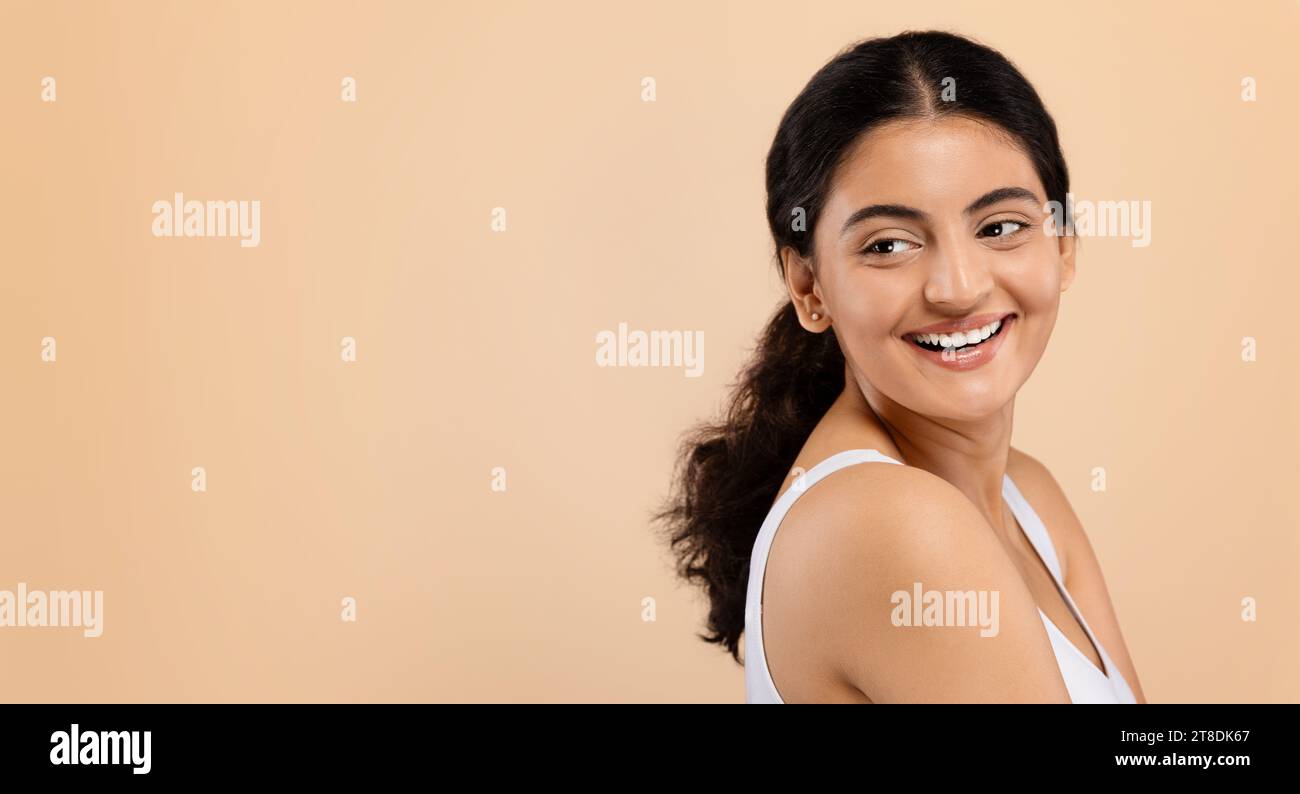 Beauty Ad. Smiling Indian Woman Looking At Copy Space Behind Her Back ...