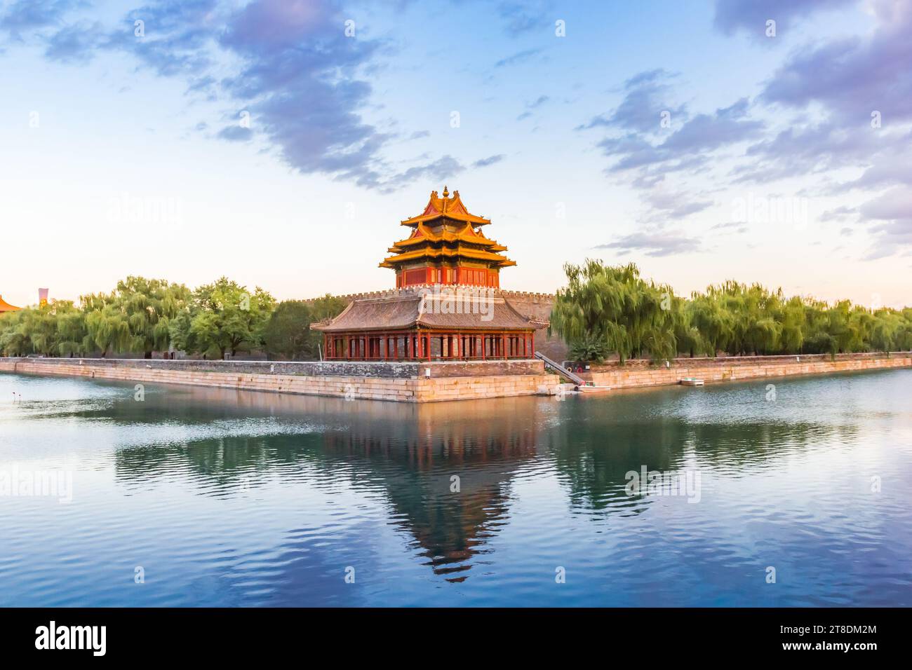 Corner tower reflected in the moat of the Forbidden City in Beijing ...