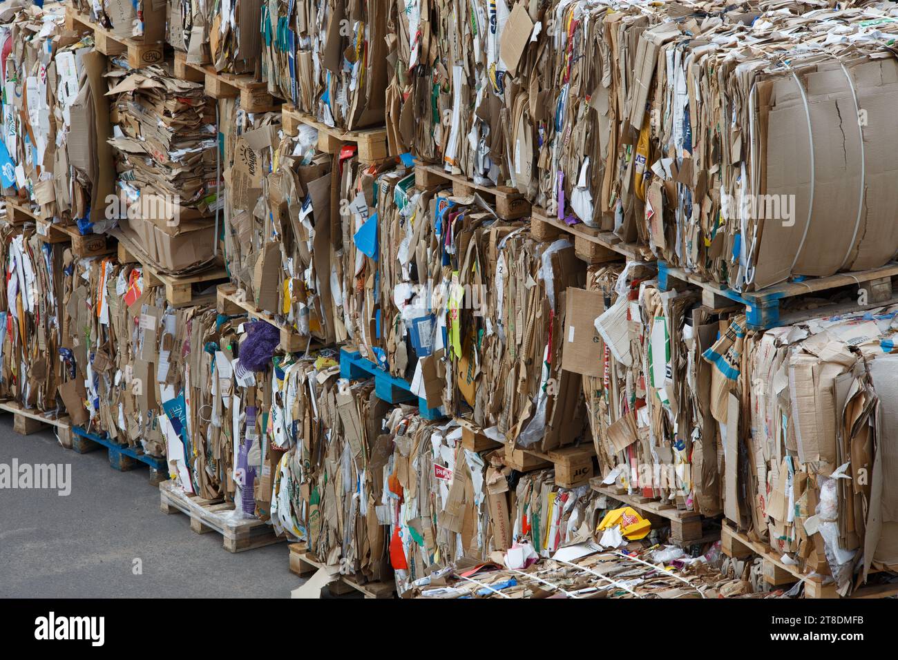 Crushed and compressed used cardboard packing poxes and paper stacked ...