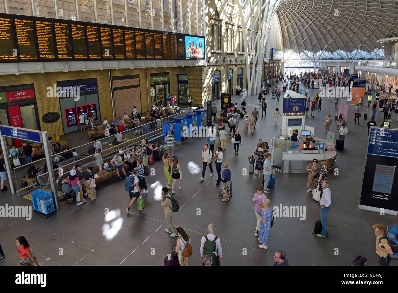 People on the main concourse waiting for trains at Kings Cross Railway ...