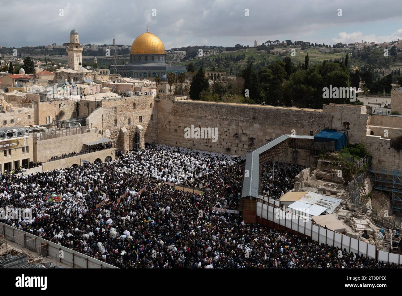 Jewish worshippers crowd into the prayer section below the Western Wall ...