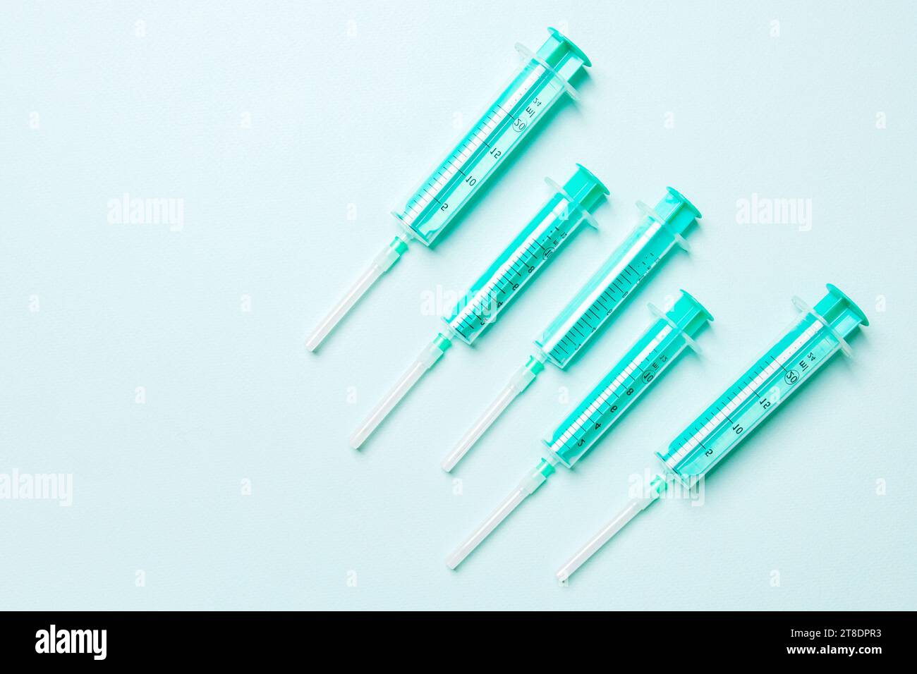 Top view of different syringes for injection on colorful background ...