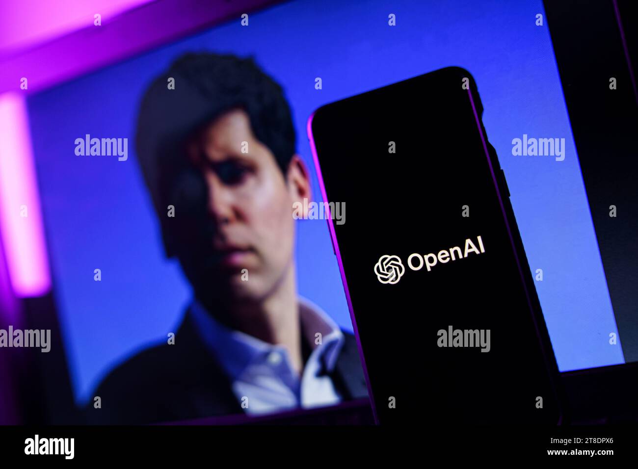 OpenAI logo and Sam Altman in background on screen. OpenAI fires CEO ... OpenAI logo and Sam Altman in background on screen. OpenAI fires CEO ...