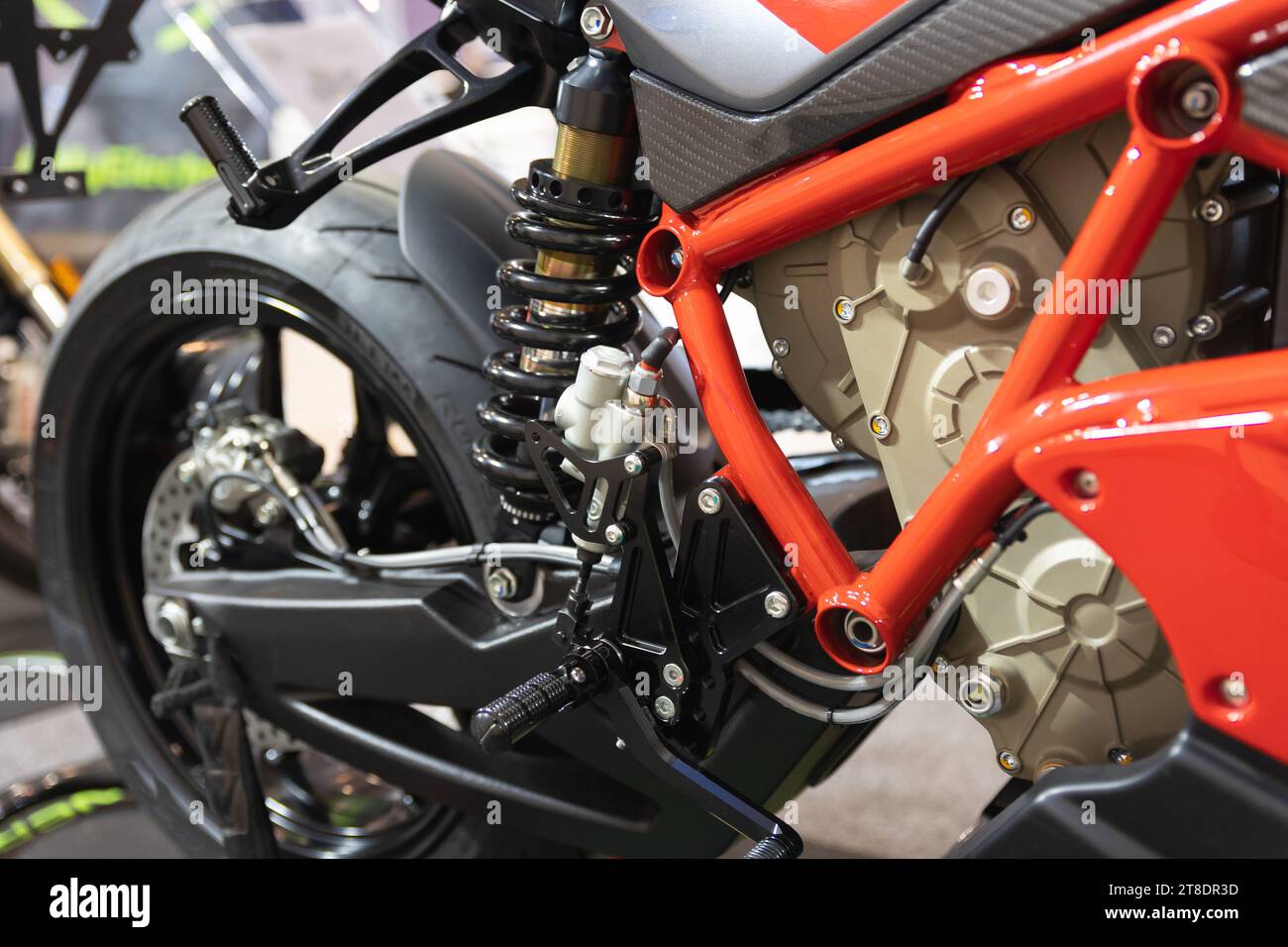 A Close Up of a Motorcycle Parked in a Garage with Electric Cars Stock ...