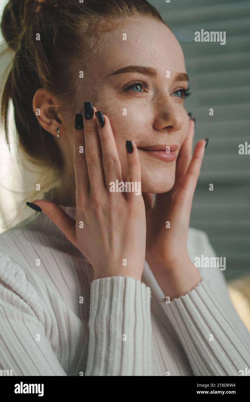 Happy confident young woman touching moisturized soft healthy sensitive ...